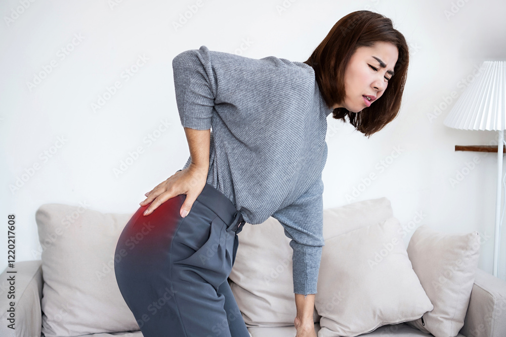 Asian woman suffering from buttock pain caused by sciatica, piriformis ...