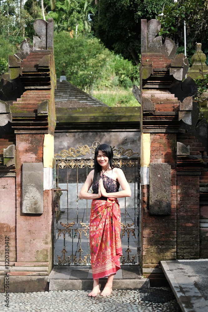 Beautiful smiling Asian woman wearing native Sarong of Bali standing ...