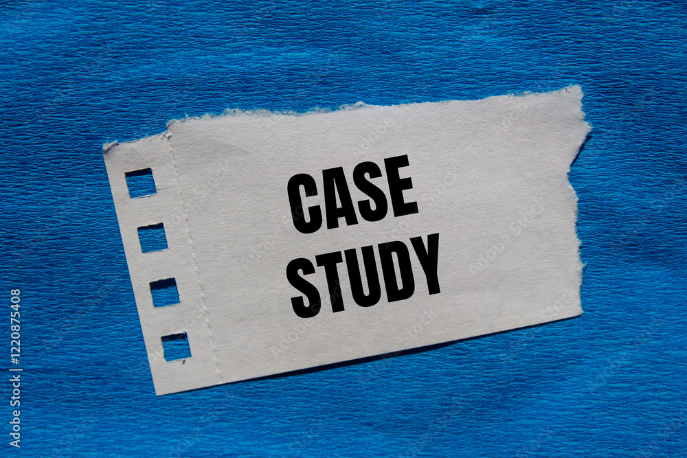 Case study message written on ripped torn paper piece with blue ...