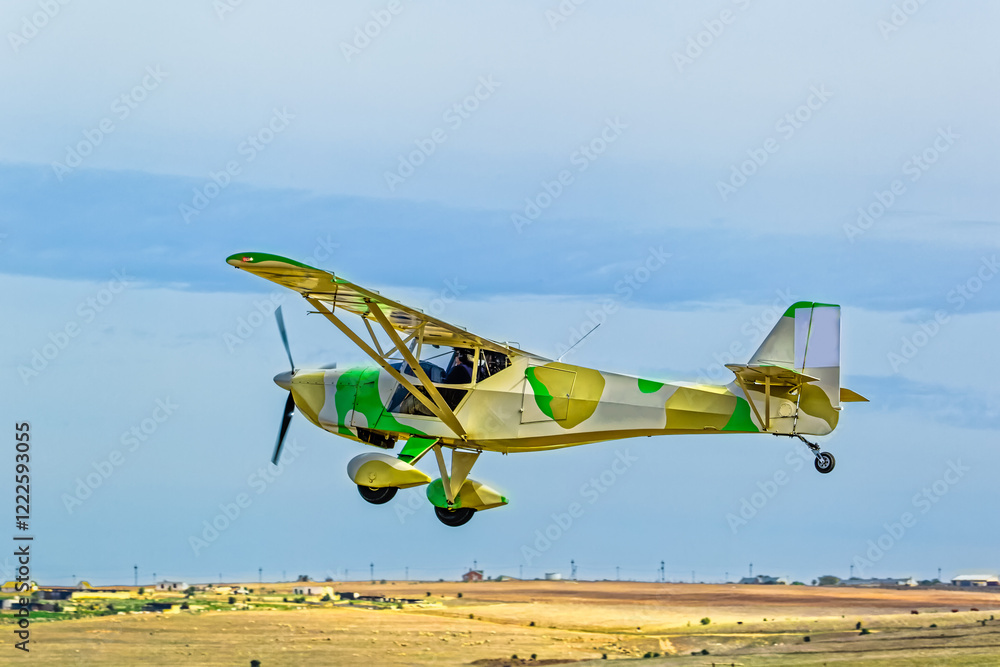 Small two-seater single engine home built kit plane with camouflage ...