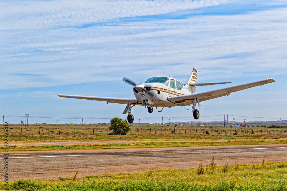 Sleek single engine four seat aircraft with high rear stabilizer and ...
