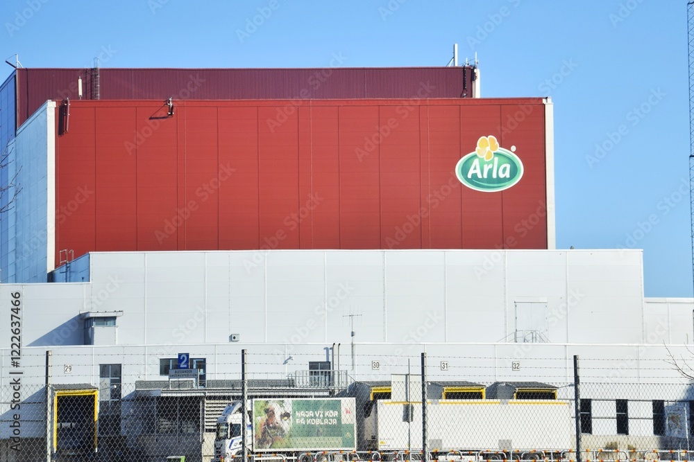 Warehouse of the modern Arla dairy plant. Signboard of the Arla Foods ...
