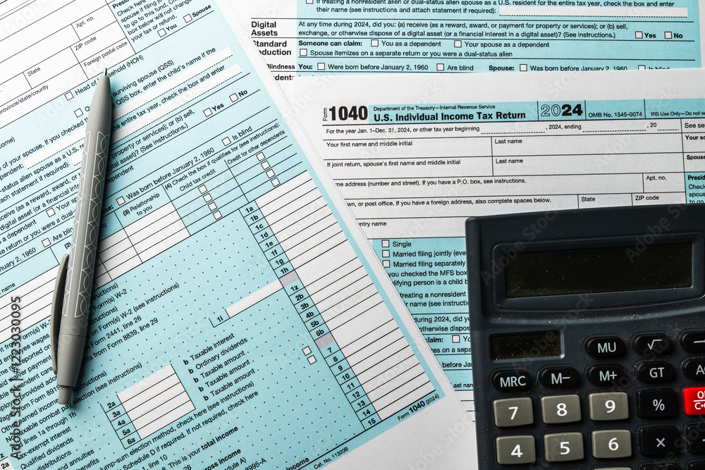 Federal income tax return preparation with 1040 form and calculator for ...