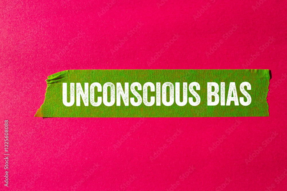 Unconscious bias message written on ripped torn green paper tape on pink background. Conceptual ...