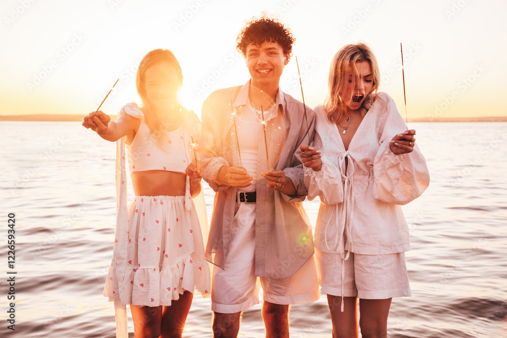 Young three smiling friends having fun during night party at the ...