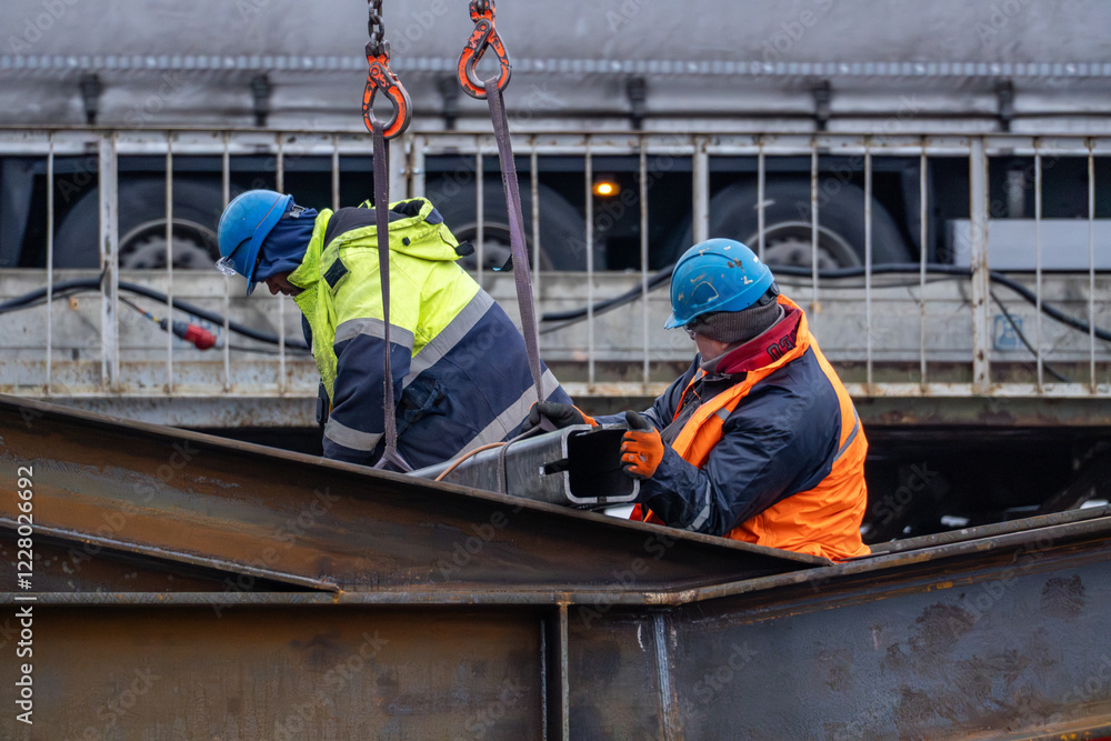 Construction Workers Assembling Steel Beams at a Bridge Site. High-Risk ...