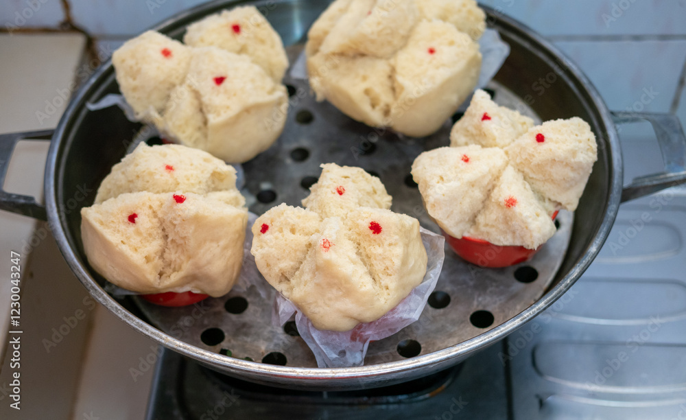 Steaming basket with Huat Kueh (Chinese prosperity cakes). Light yellow ...