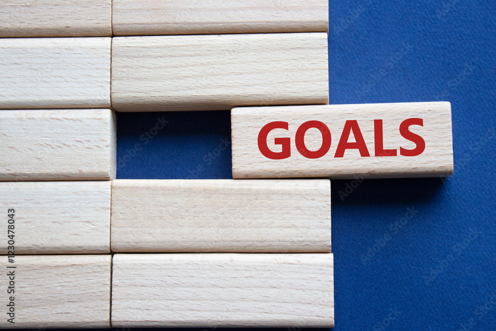Goals symbol. Concept word Goals on wooden blocks. Beautiful deep blue ...