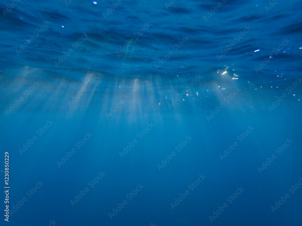 Dark blue ocean surface seen from underwater. Abstract waves underwater ...