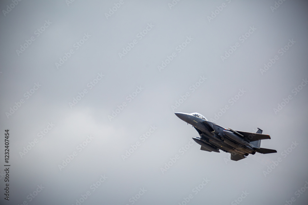 F15 fighter jet taking off from RAF Lakenheath with a cloudy background ...