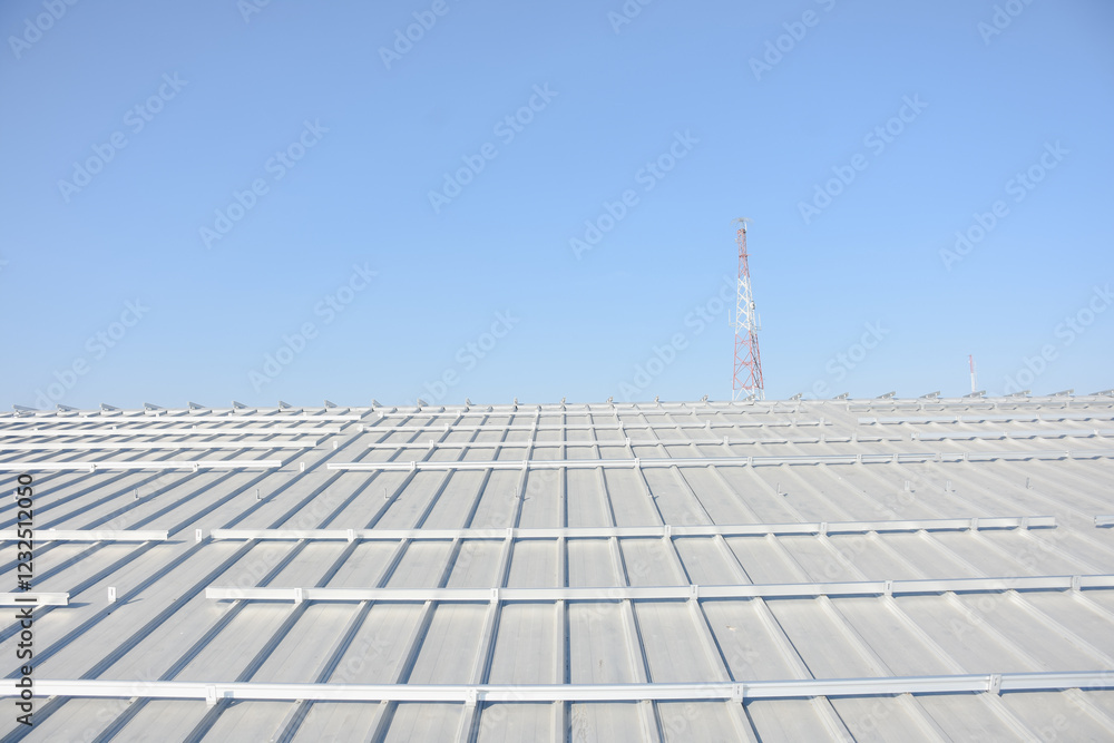 sloped metal roof. The roof has a series of parallel ridges and is ...