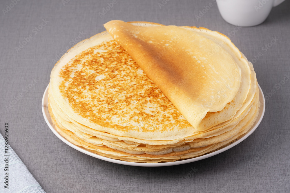 Stack of traditional russian pancakes blini on gray background ...