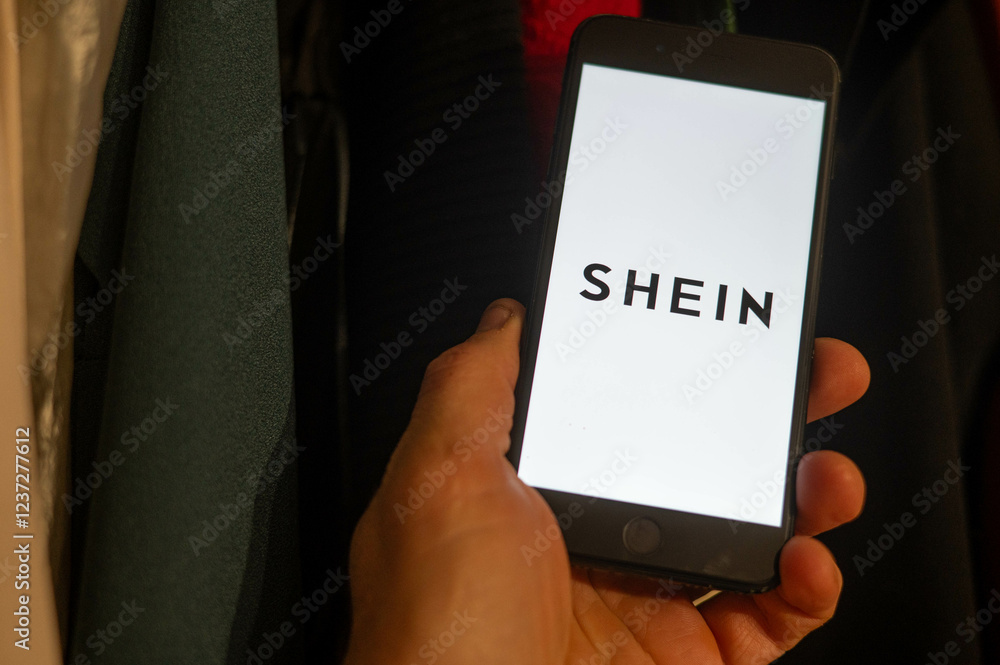Shein logo is displayed on smartphone.Shein is a fast fashion retailer ...
