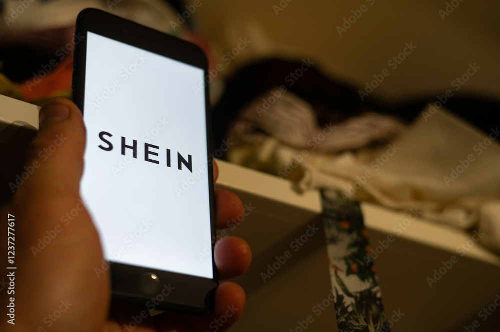 Shein logo is displayed on smartphone.Shein is a fast fashion retailer ...