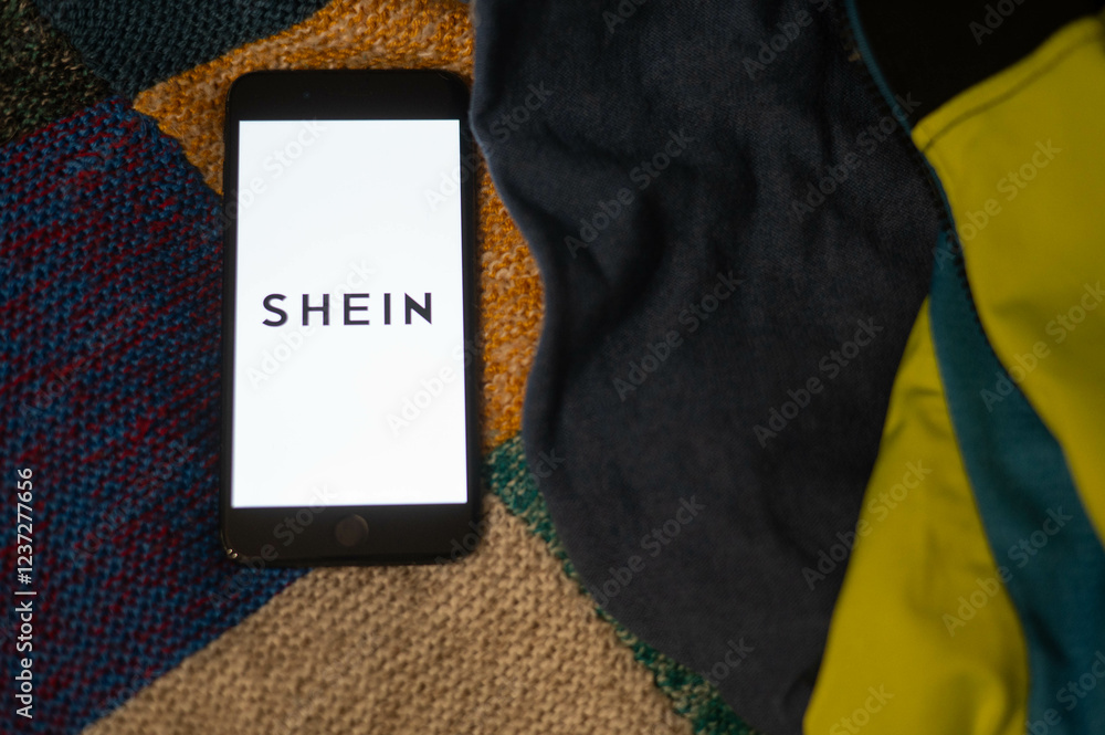 Shein logo is displayed on smartphone.Shein is a fast fashion retailer ...