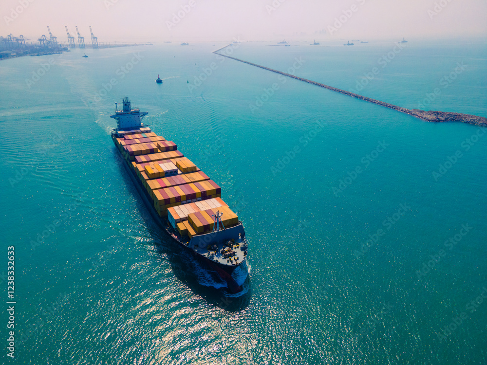 the aerial perspective of a cargo ship being loaded and unloaded at a ...