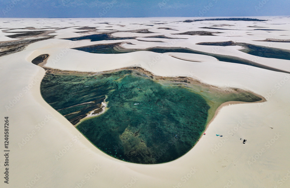 Aerial view of breathtaking sand dunes and tranquil lagoon in lencois maranhenses, barreirinhas ...