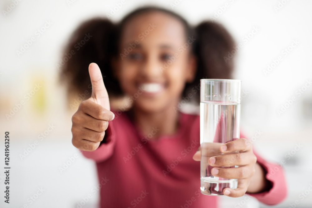 Foto de Stock Selective focus on glass of water and thumb up ...