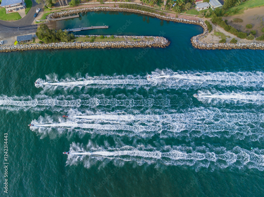 Jet skis racing past a boat ramp Stock Photo | Adobe Stock
