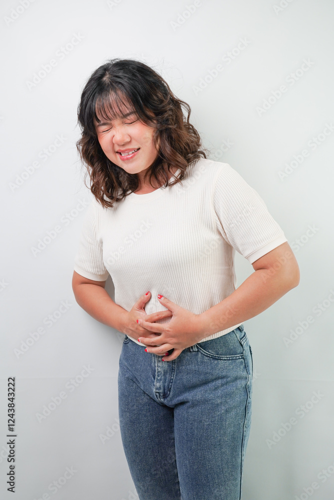 Beautiful young asian woman with wavy hair wearing white shirt is ...