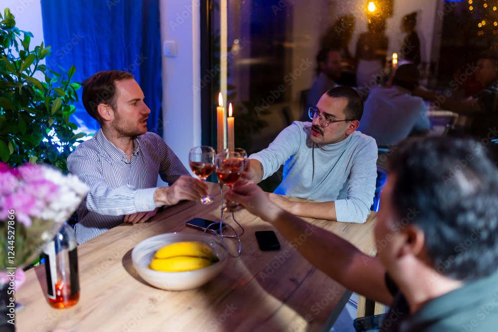 Friends enjoying a dinner gathering, sharing moments and toasting ...