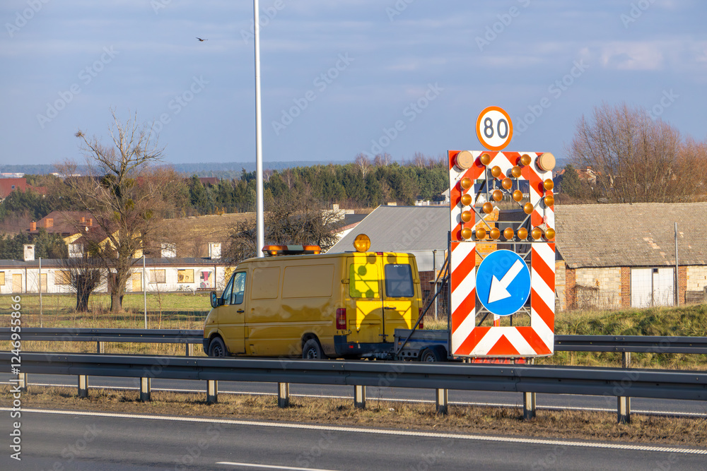 car with trailer with road signs warning about construction and repair ...