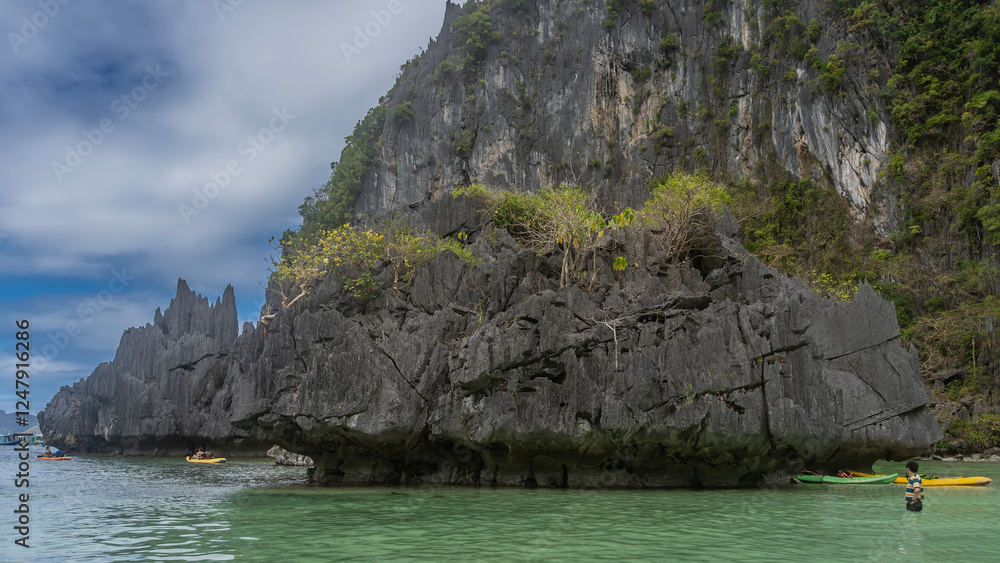 Picturesque karst cliffs in the turquoise ocean. Green vegetation on ...