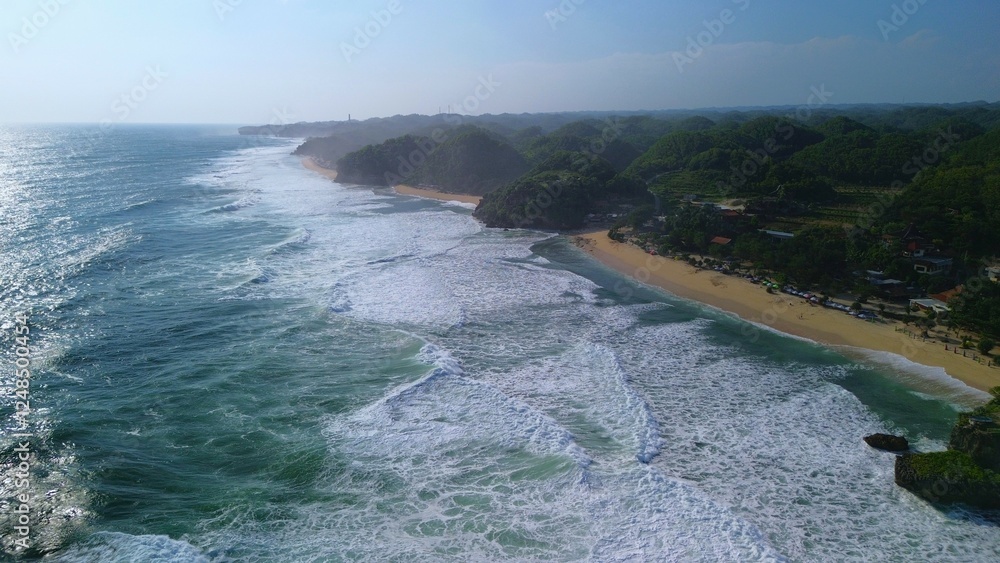 Aerial Drone view of the beach with white sand, coral rocks, hills with ...
