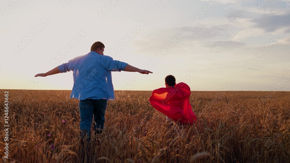 Dad son dream of becoming superheroes. Child, father in red cloak, sun ...