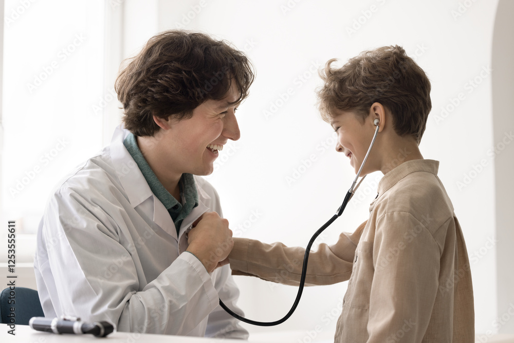 Playing doctor. Laughing child boy pretend doc on pediatrician ...