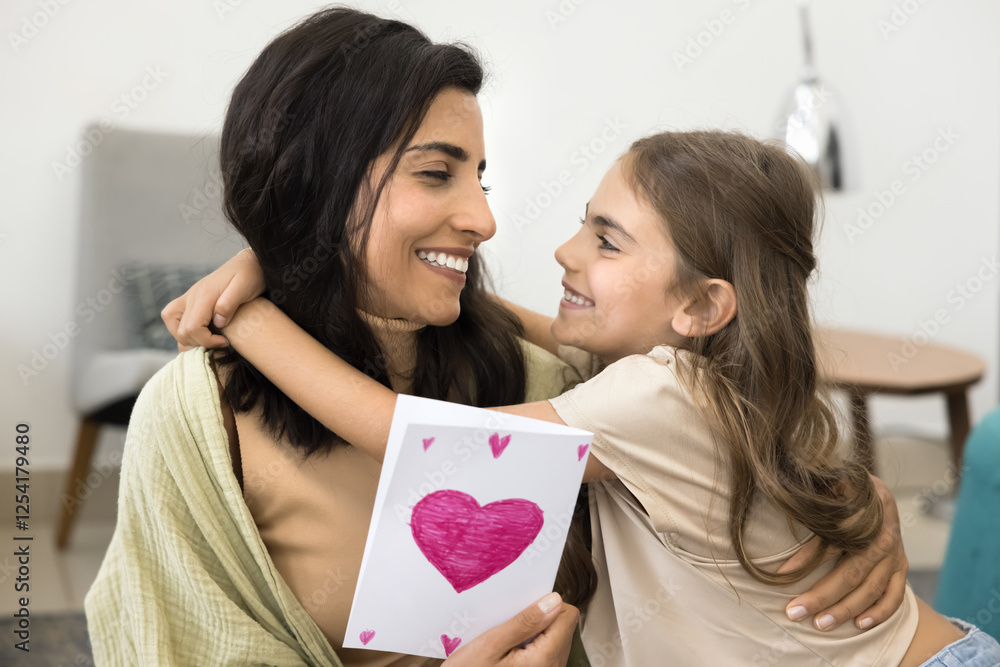 Daughter congratulate mother on holiday. Beautiful woman get homemade ...