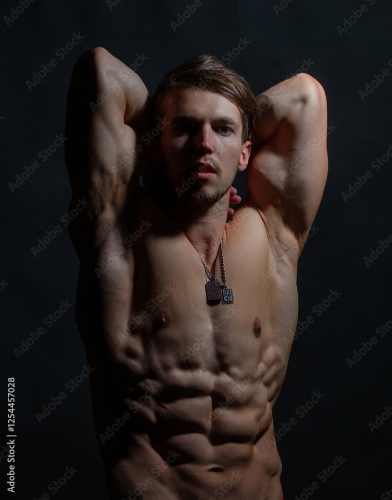 Shirtless man posing. Muscular male model in studio. Sexy man. Fit athlete showing six-pack abs ...