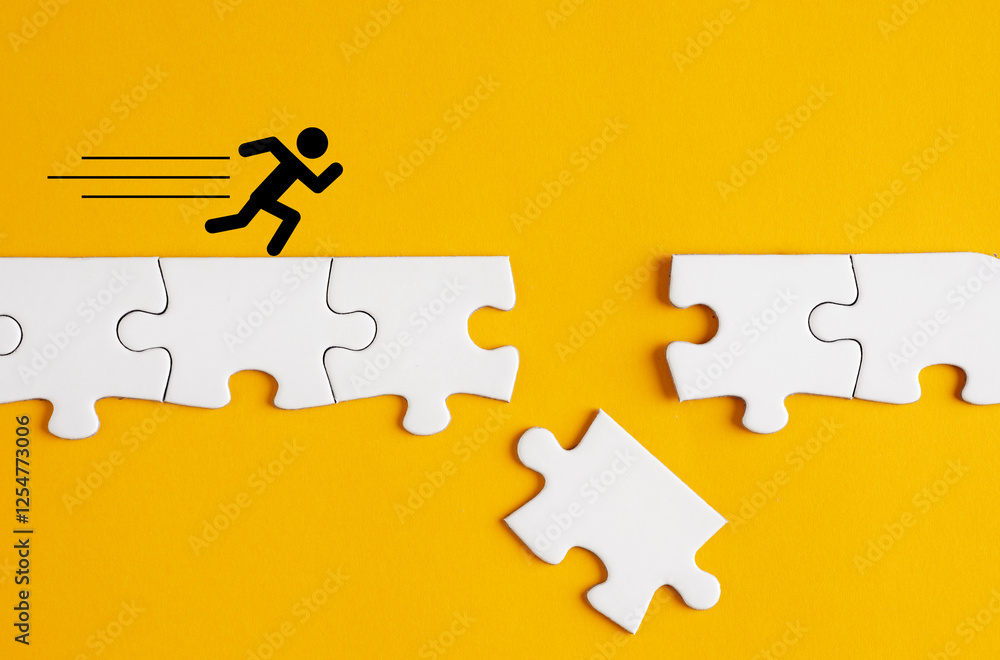 Businessman running and jumping over a gap in puzzle bridge on yellow ...