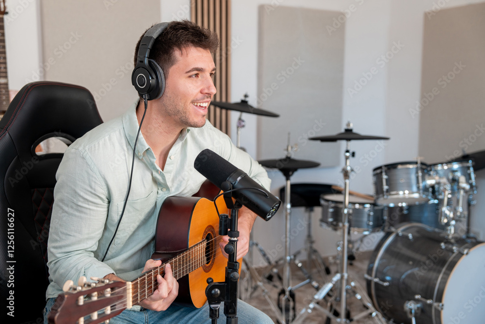 Smiling Musician Recording Acoustic Guitar and Vocals in Studio. A man ...