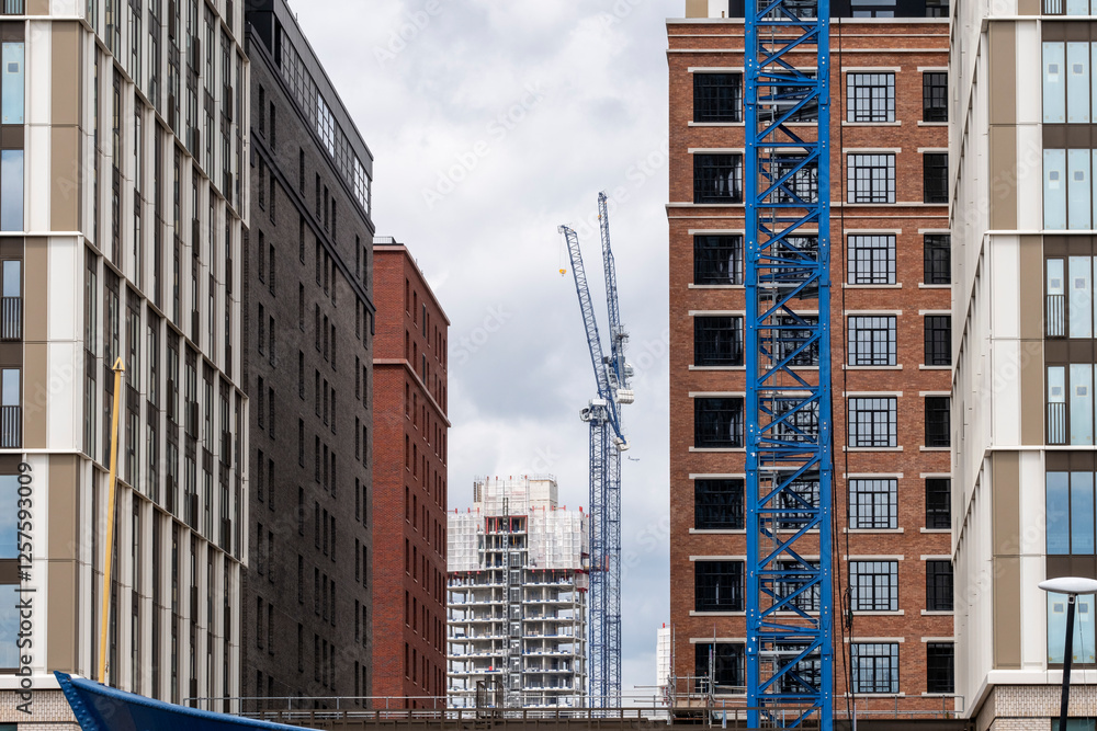 Dense cluster of modern apartment buildings with varied architectural ...