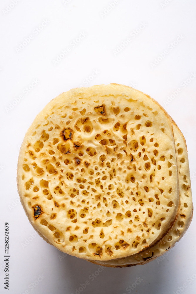 Stack of crumpet, a small griddle bread made from batter of milk or ...