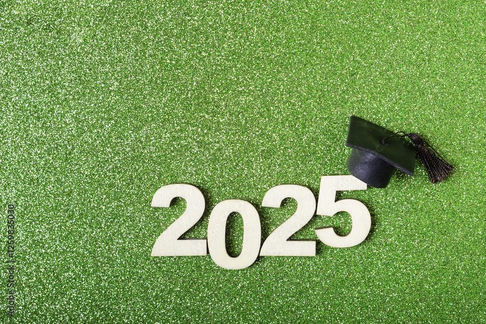 Graduation cap on wooden number 2025 on glitter green background. Class ...