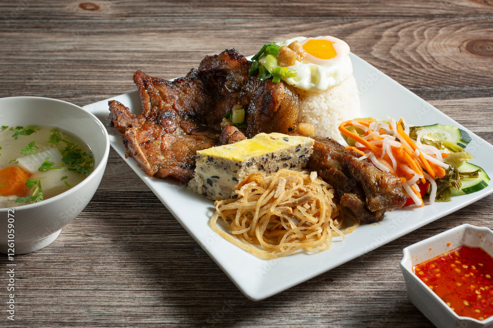 A view of a Vietnamese entree called com tam dac biet, consisting of ...