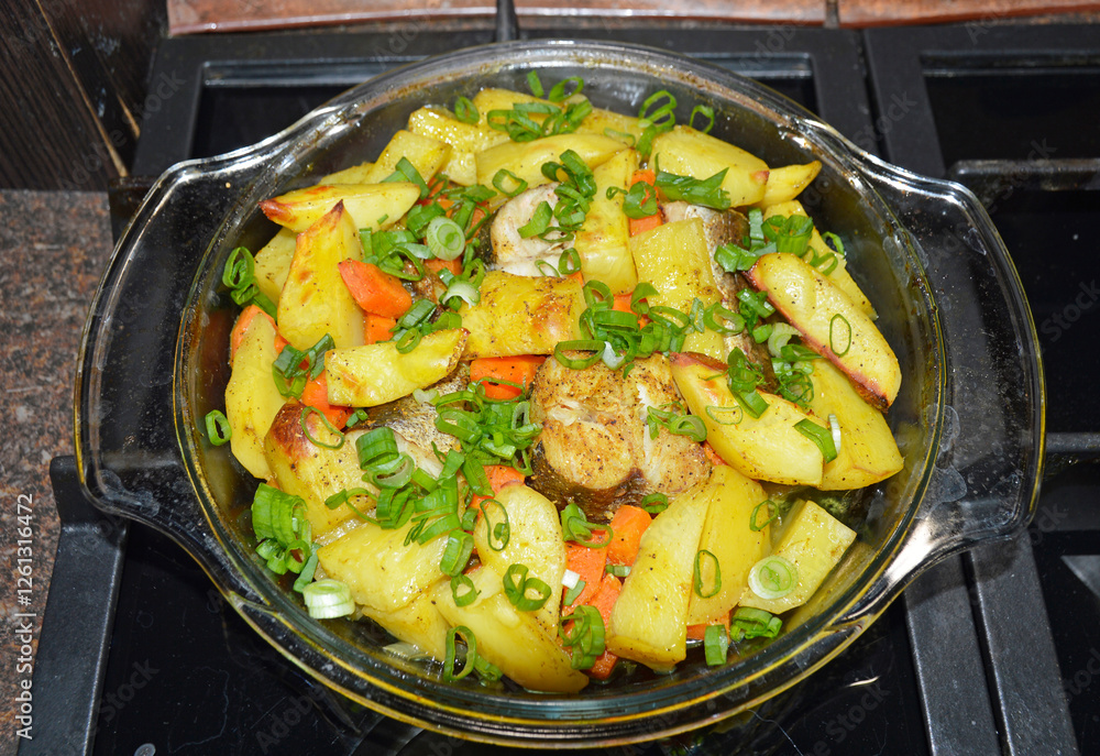 hake fish baked with potatoes and carrots. tasty and healthy food for ...