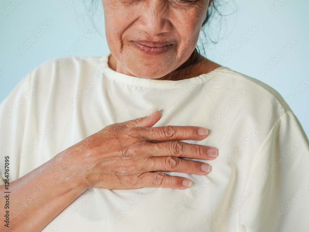 Lifestyle health care concept. Asian woman holding her chest with her ...