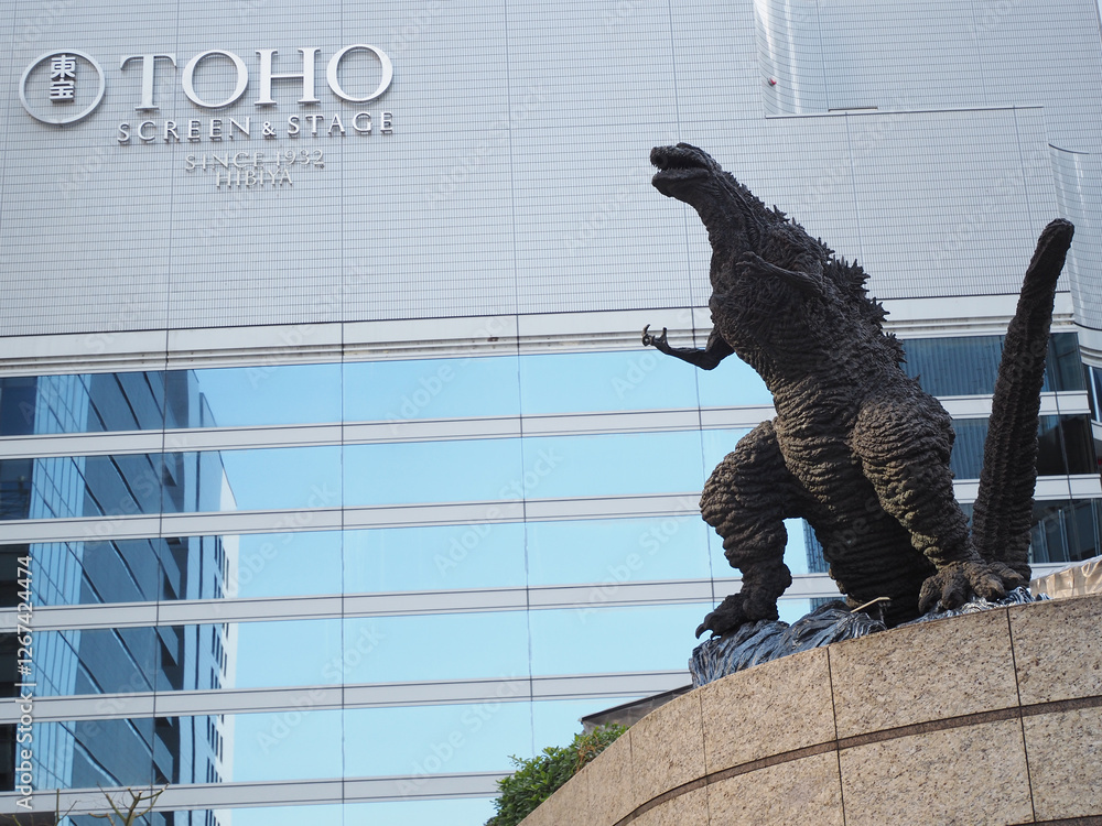 TOKYO, JAPAN - February 15, 2025: A statue of Godzilla in Godzilla Square in front of a Toho ...