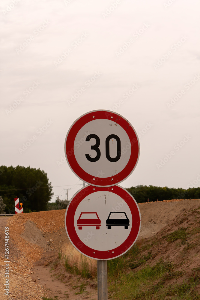 Speed limit and no overtaking road signs at construction site Stock ...