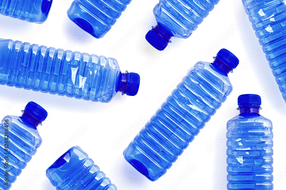 Pattern with blue plastic bottles isolated on white, top view empty ...