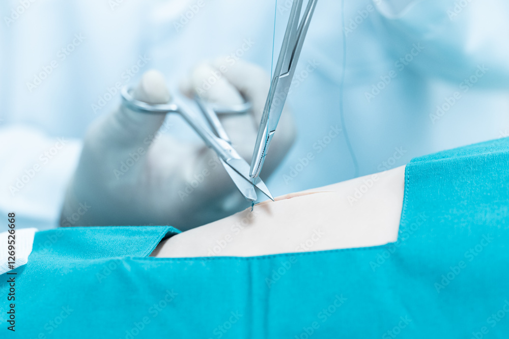Doctor hand wear sterile gloves and surgery scissor stitching up wound ...