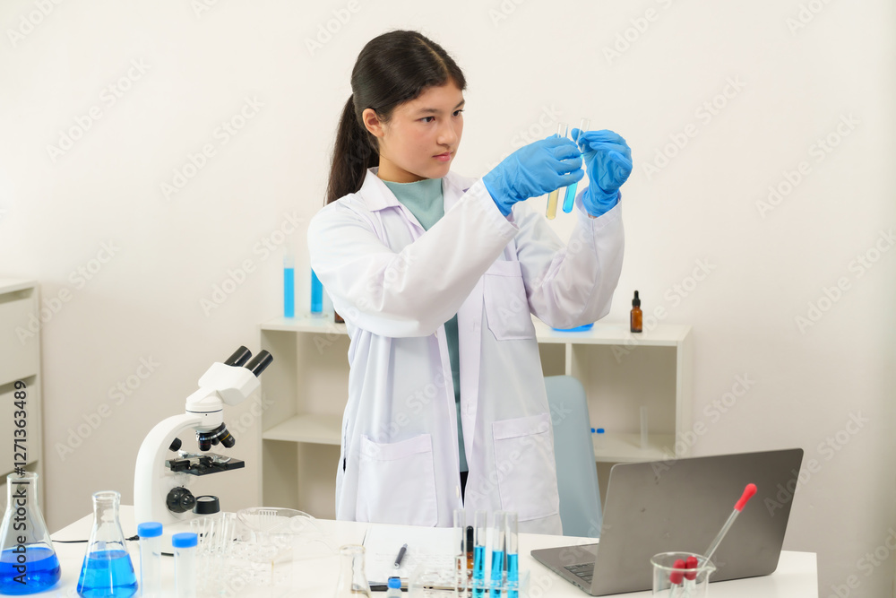 Caucasian school children learning experiment in science classroom ...