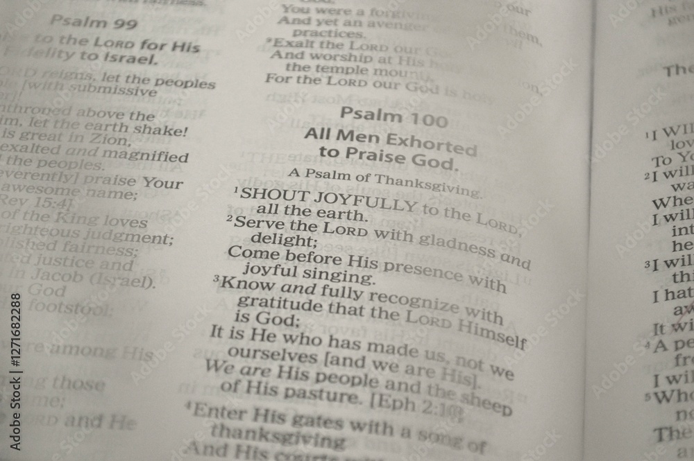 An open Bible displays Psalm 100, calling all men to praise God joyfully Stock Photo | Adobe Stock