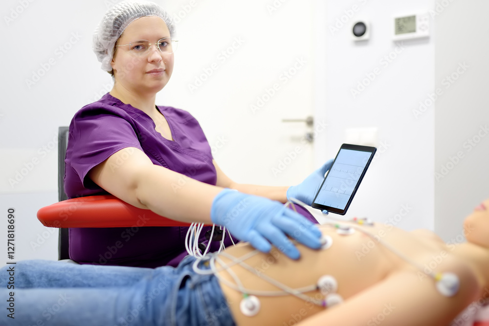 Child under ECG test with doctor. Boy patient lying in medical bed with ...