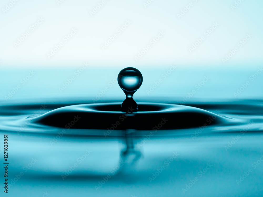 Blue Water droplet on light blue background floating in the air in ...
