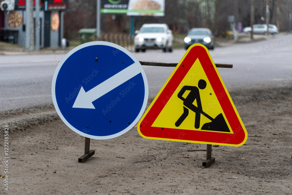 Two traffic signs point towards road construction, guiding drivers on a ...