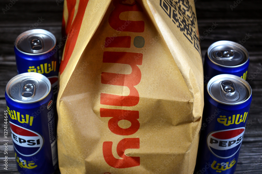Cairo, Egypt, February 8 2025: Pepsi cans and Wimpy delivery fast food ...
